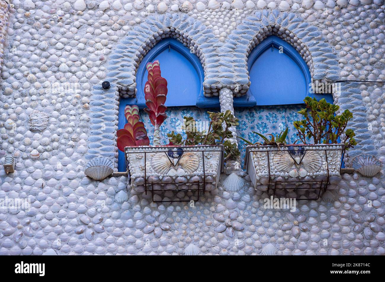 Cute and handmade windows in a facade decorated with pleasant marine ...