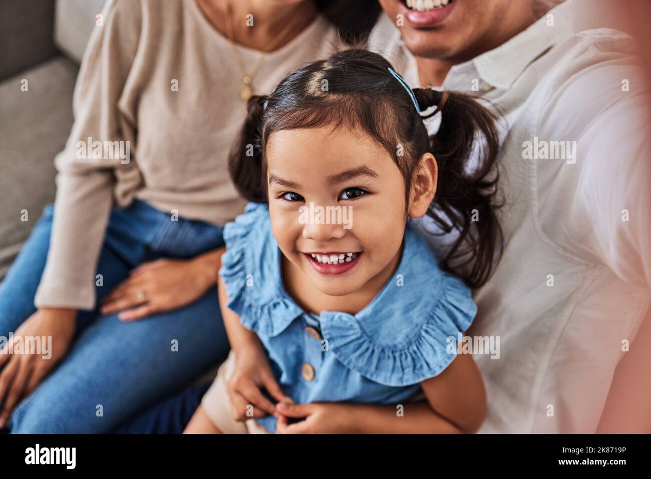 Selfie, family and young happy girl together bonding on living room sofa. Portrait of adorable ...