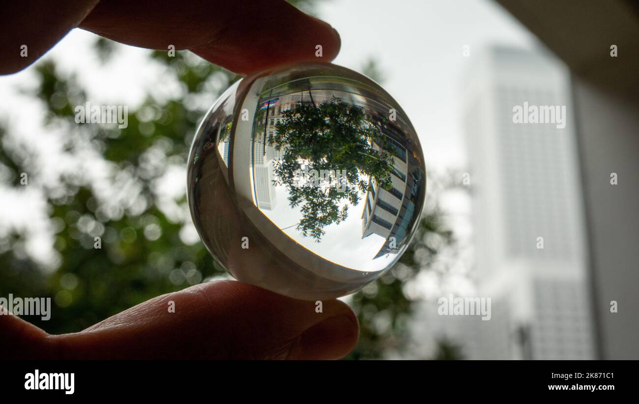The urban landscape of Singapore through a glass ball Stock Photo - Alamy