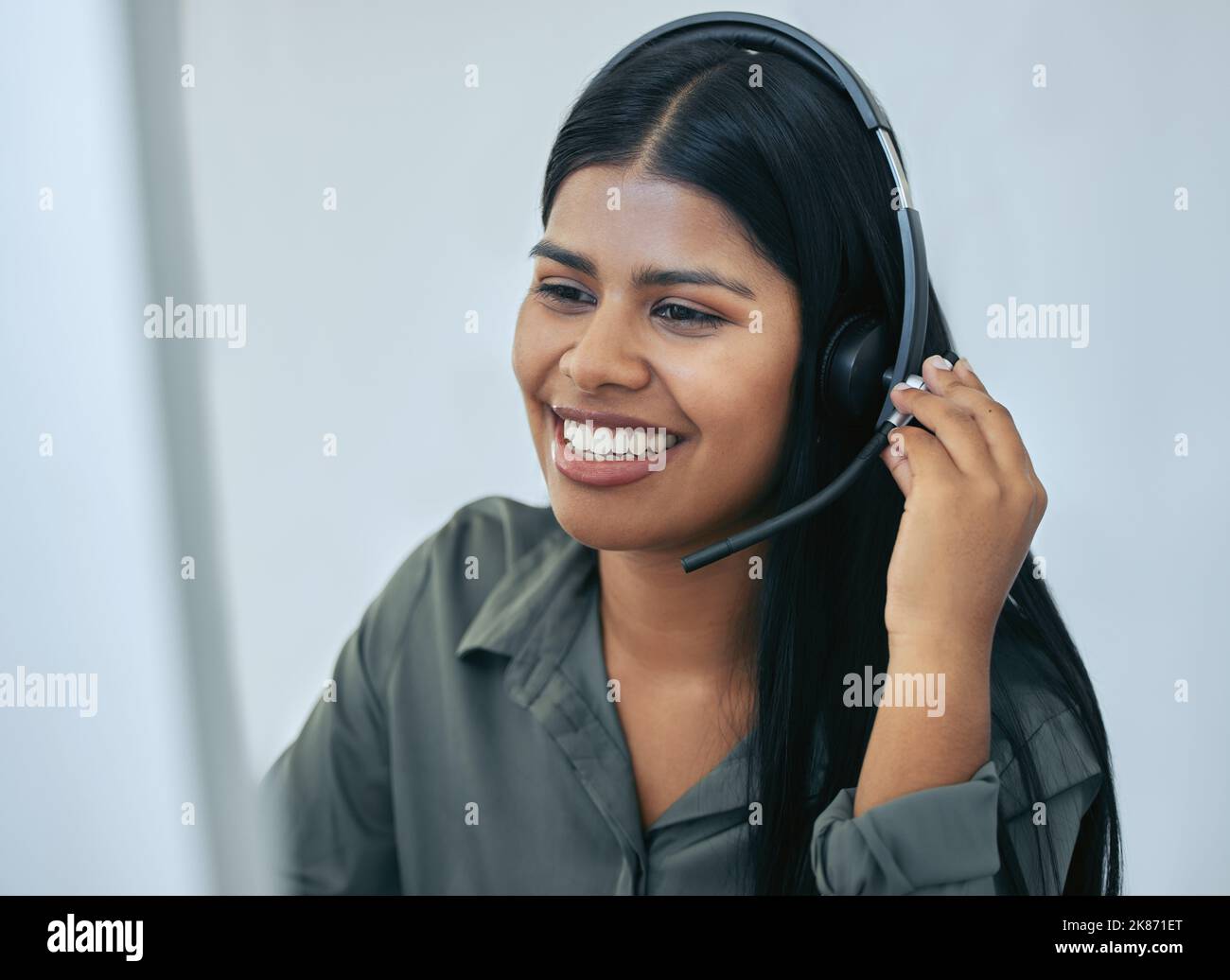 I hear you loud and clear. an attractive young saleswoman sitting alone in her office and ...