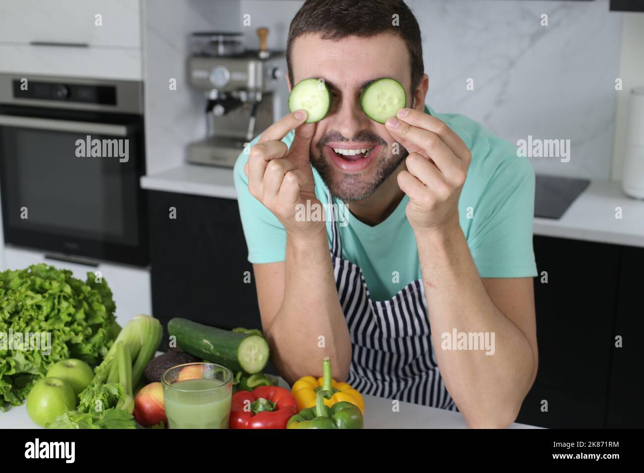 Man using cucumber slices to cover eyes Stock Photo - Alamy
