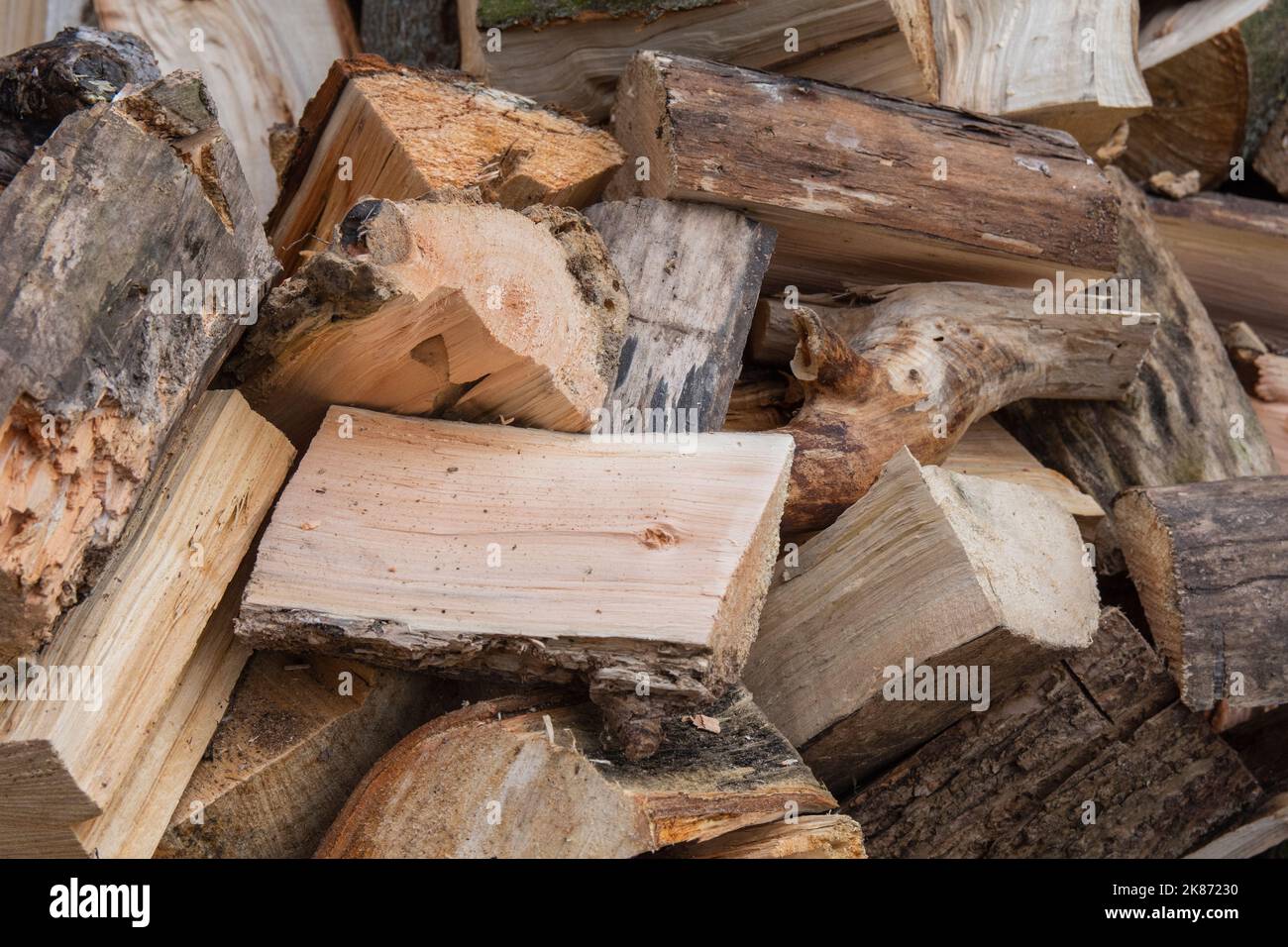 Tree trunks cut and chopped in a heap ready to be laid Stock Photo - Alamy
