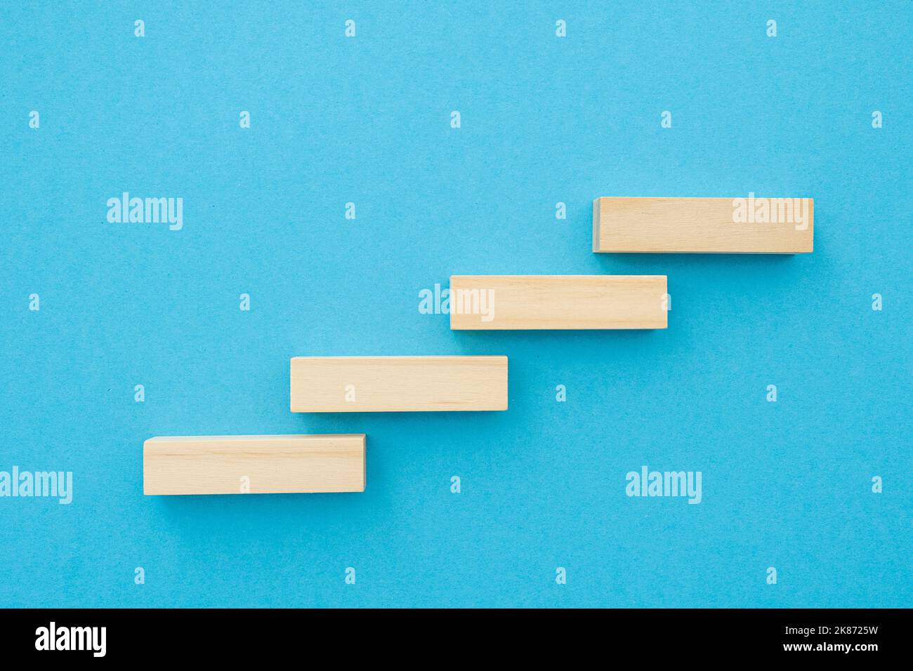 Four wooden small planks, long shape with blank surface growing up on ...