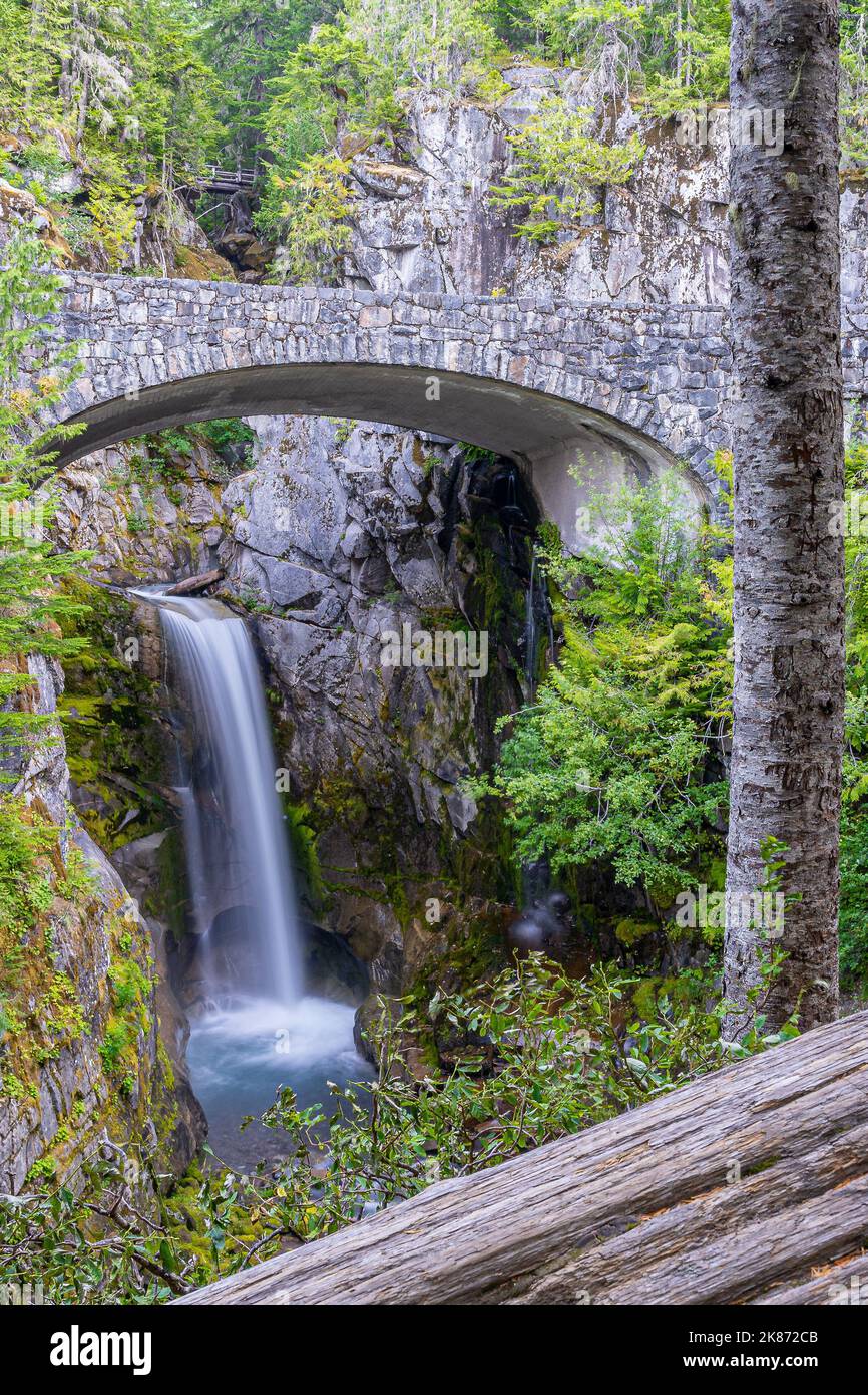 A vertical long-exposure view of Christine Falls under the stone bridge ...