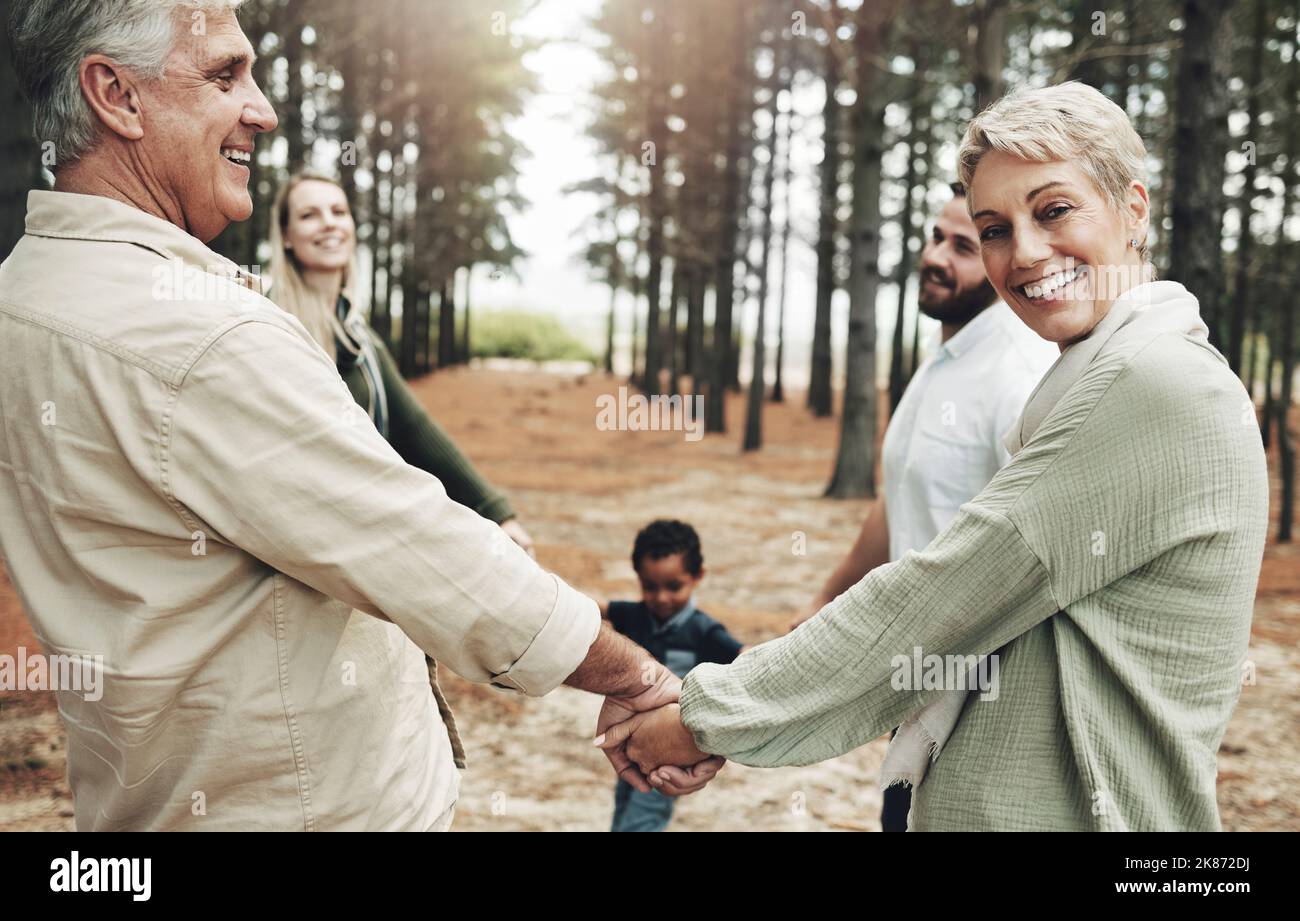 Diversity, holding hands and family on forest nature walk for bonding ...