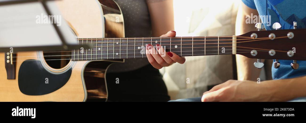 Female teacher explain notes to client on guitar instrument, music ...