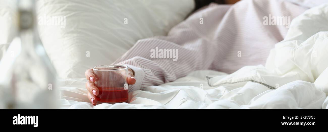 Woman In Bed After Fun Night Hold Glass With Alcoholic Drink Drunk