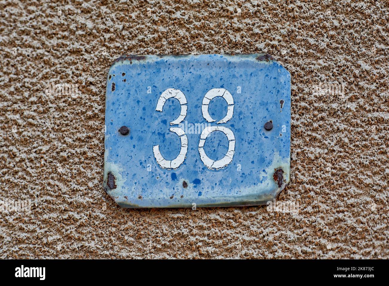 House name plate number 38 written in white on a blue background, on an ...