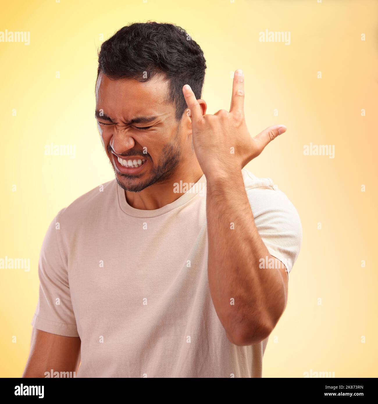 I can feel it in my bones. a young man showing the rock n roll hand ...