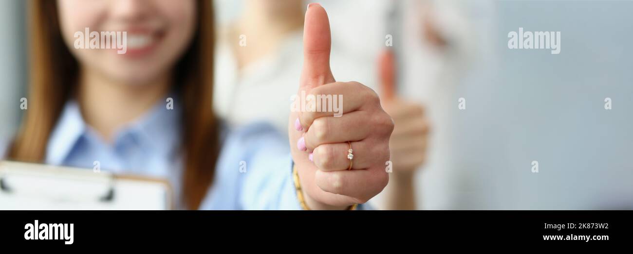 Smiling female showing thumbs up and confirm success on camera Stock ...