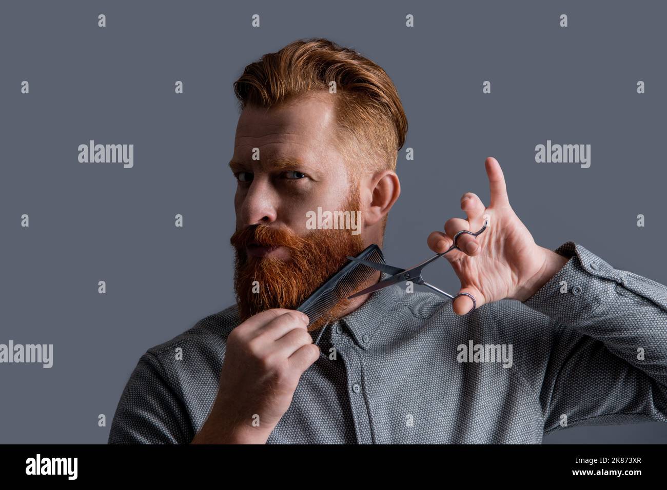 caucasian barber man haircutting hairstyle isolated on grey background ...