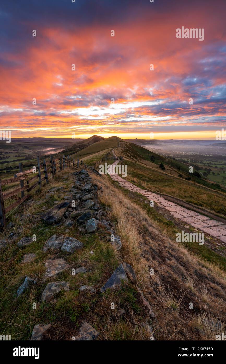 The Great Ridge and path at sunrise with fiery sky, The Peak District ...