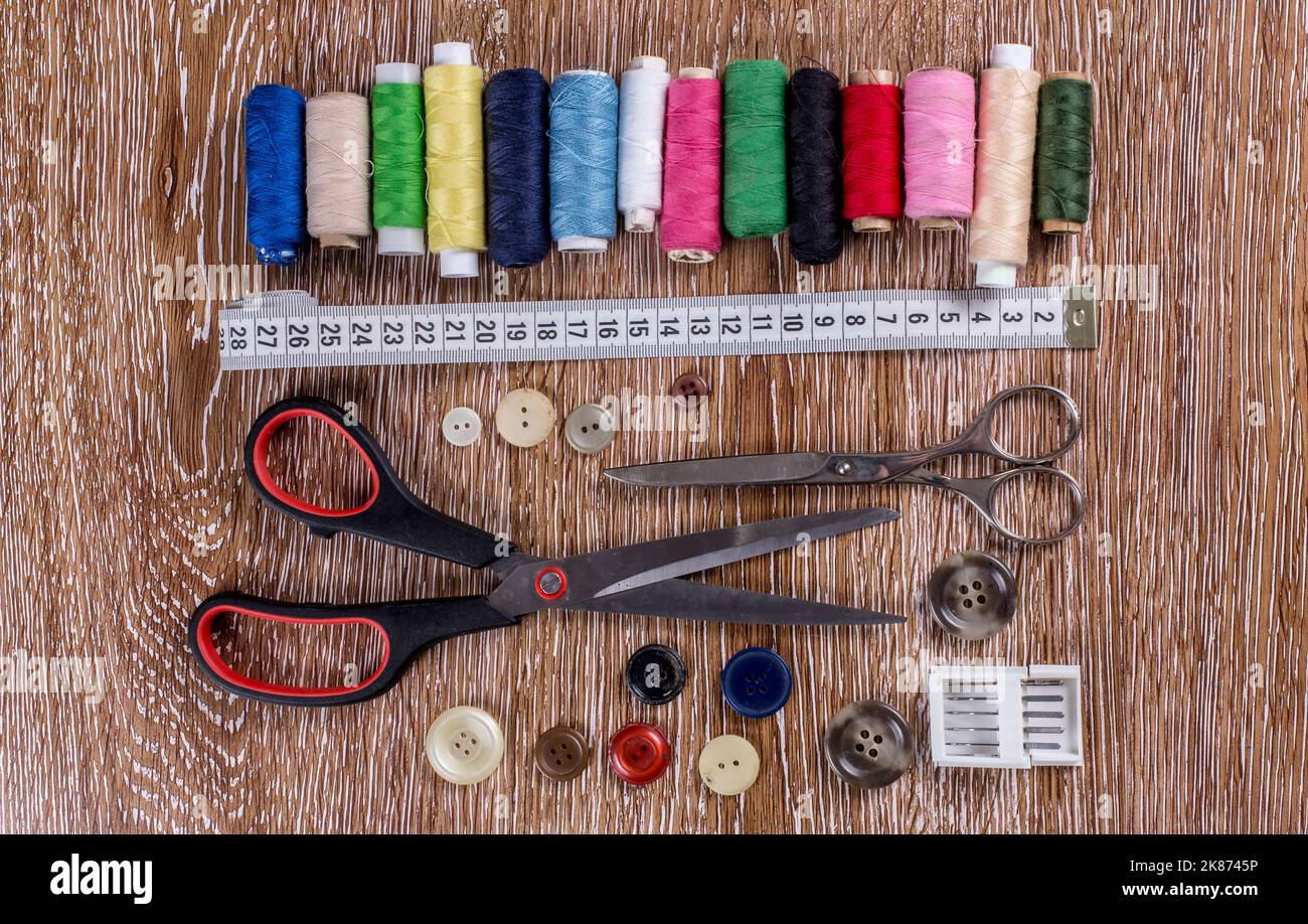 Sewing tools on wooden background Stock Photo - Alamy