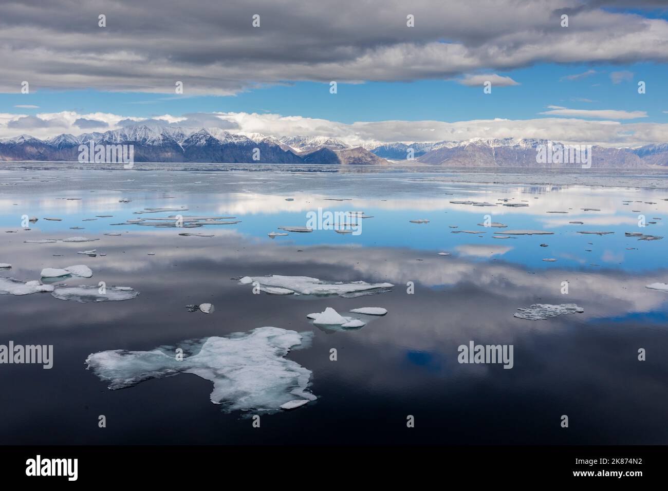 A view of the snow covered mountains surrounding Pond Inlet, Nunavut ...