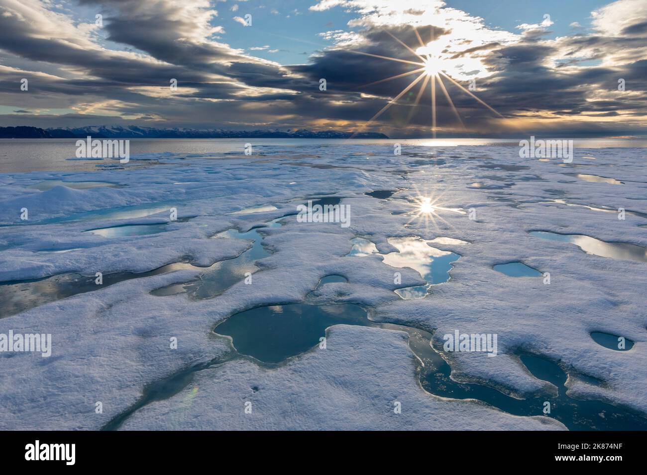 Sunburst over fast ice in Lancaster Sound, between Devon Island and ...