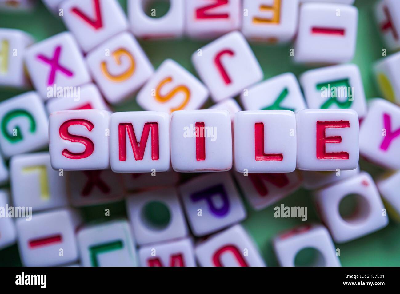 smile word with red cube letters, feelings and emotions Stock Photo - Alamy