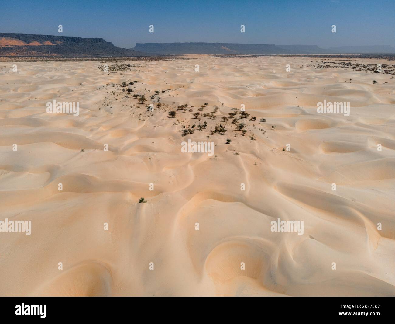 A stretch of white dunes surrounded by canyons near Kamour, Mauritania ...