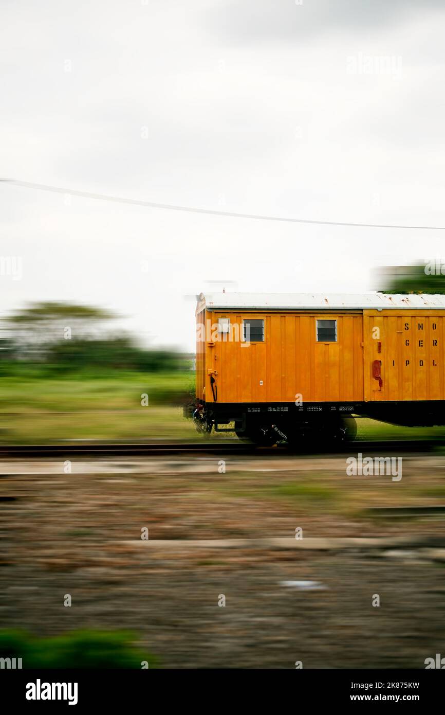 motion blur of rustic yellow wagon train on railway Stock Photo - Alamy