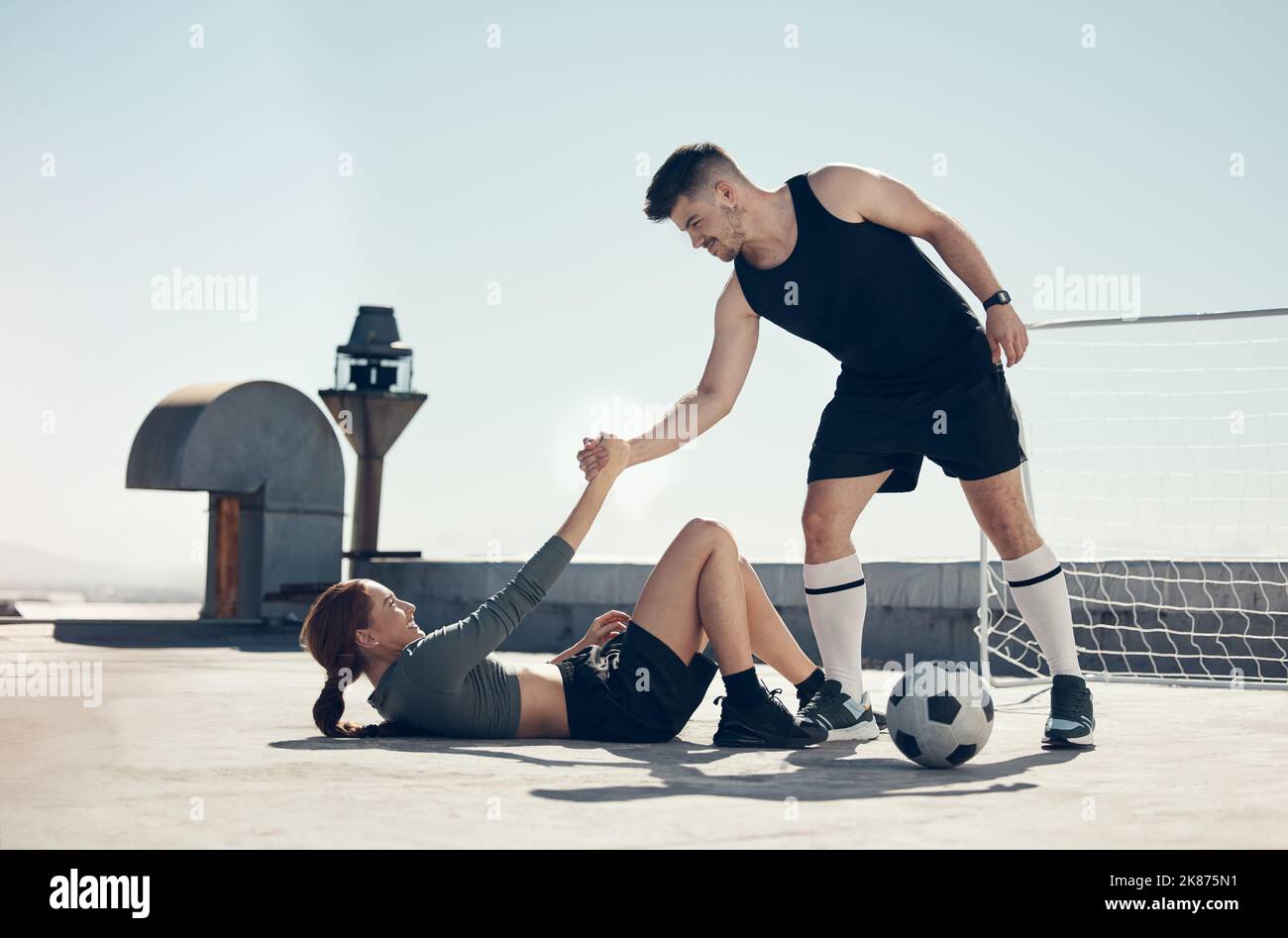 Teamwork, soccer and helping player in sports game, playing football on ...