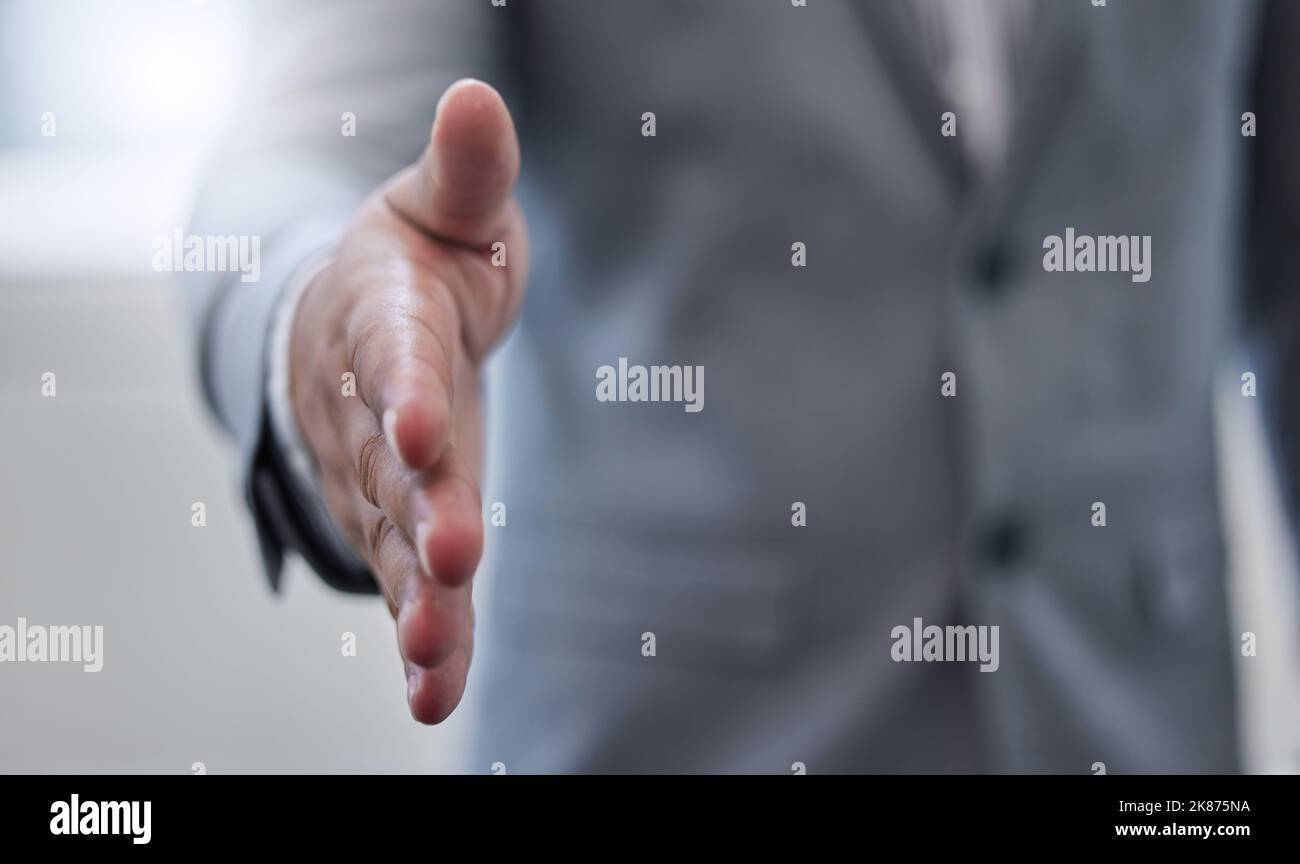 Pleased to meet you. a businessman holding out his hand for a handshake ...