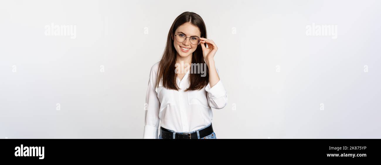 Portrait of female office worker, businesswoman looking at camera and ...