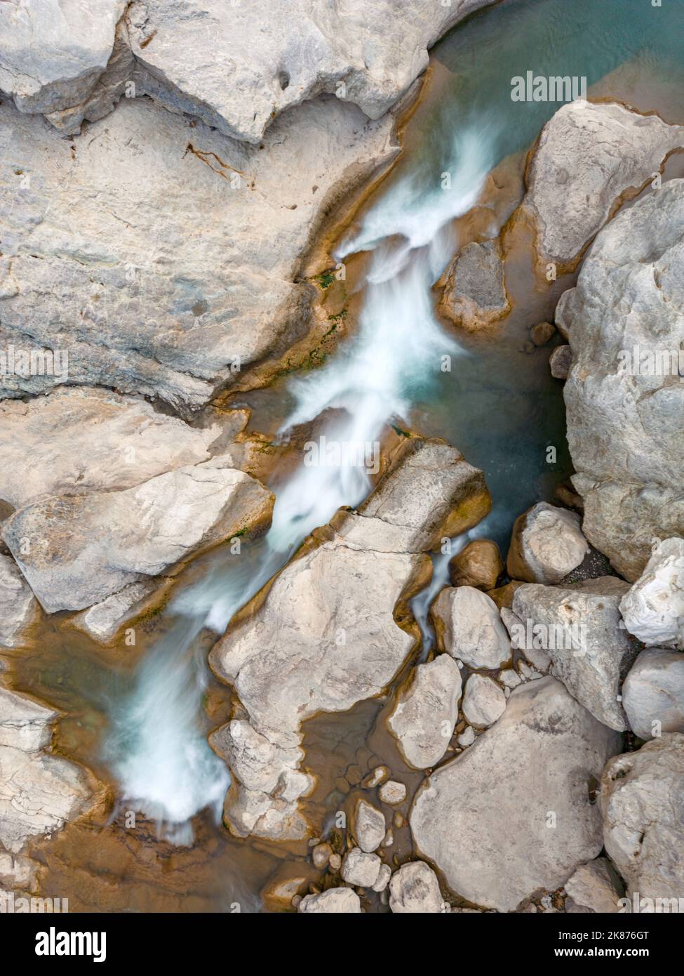 River flowing between rocks with motion blur shot with long exposure ...