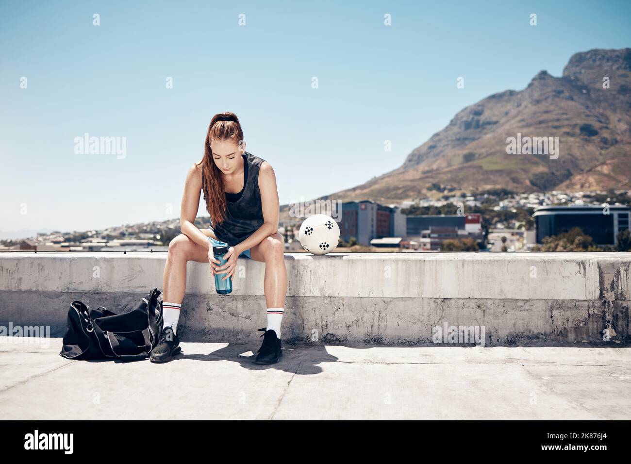 Sports athlete, woman rest on rooftop and water break after rooftop ...