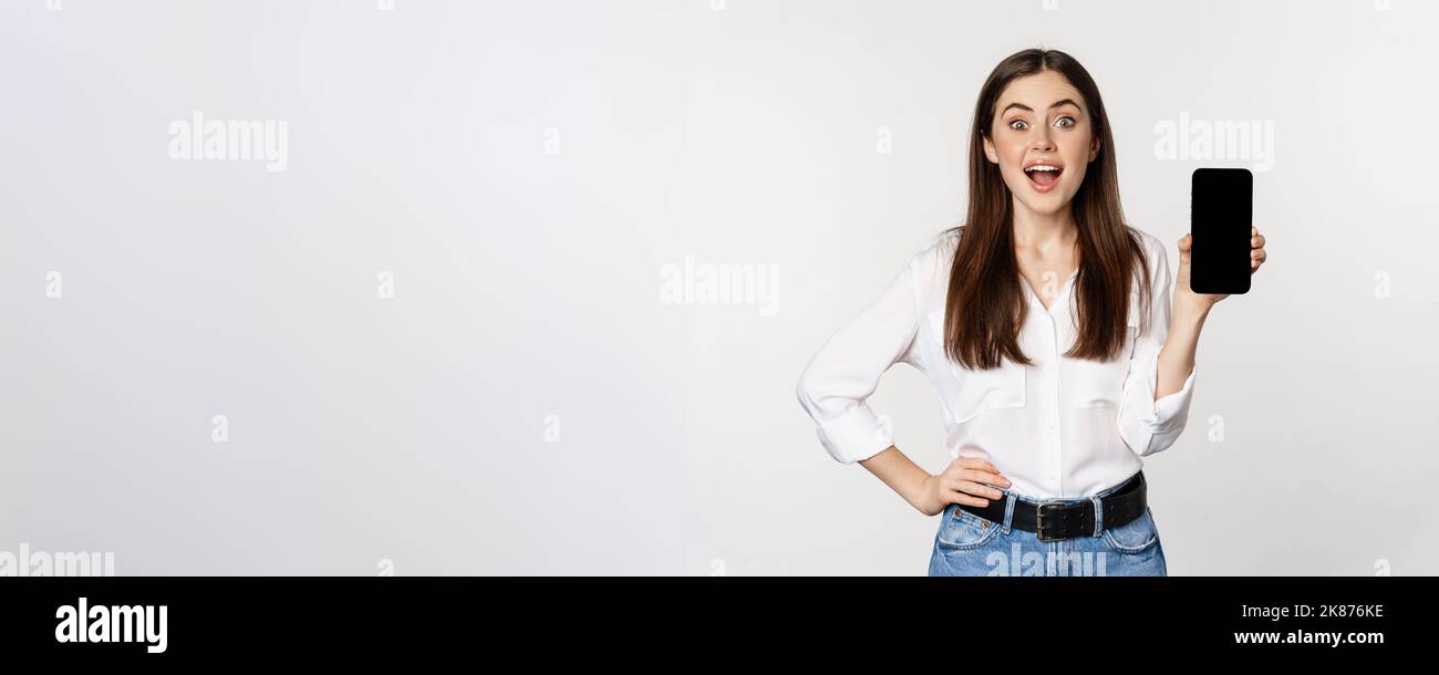 Happy smiling woman showing smartphone app interface, mobile phone ...
