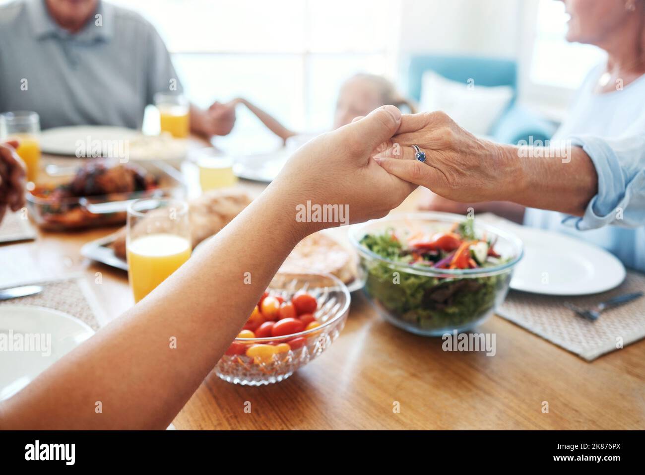 Christian, family and pray for food holding hands for lunch together at ...