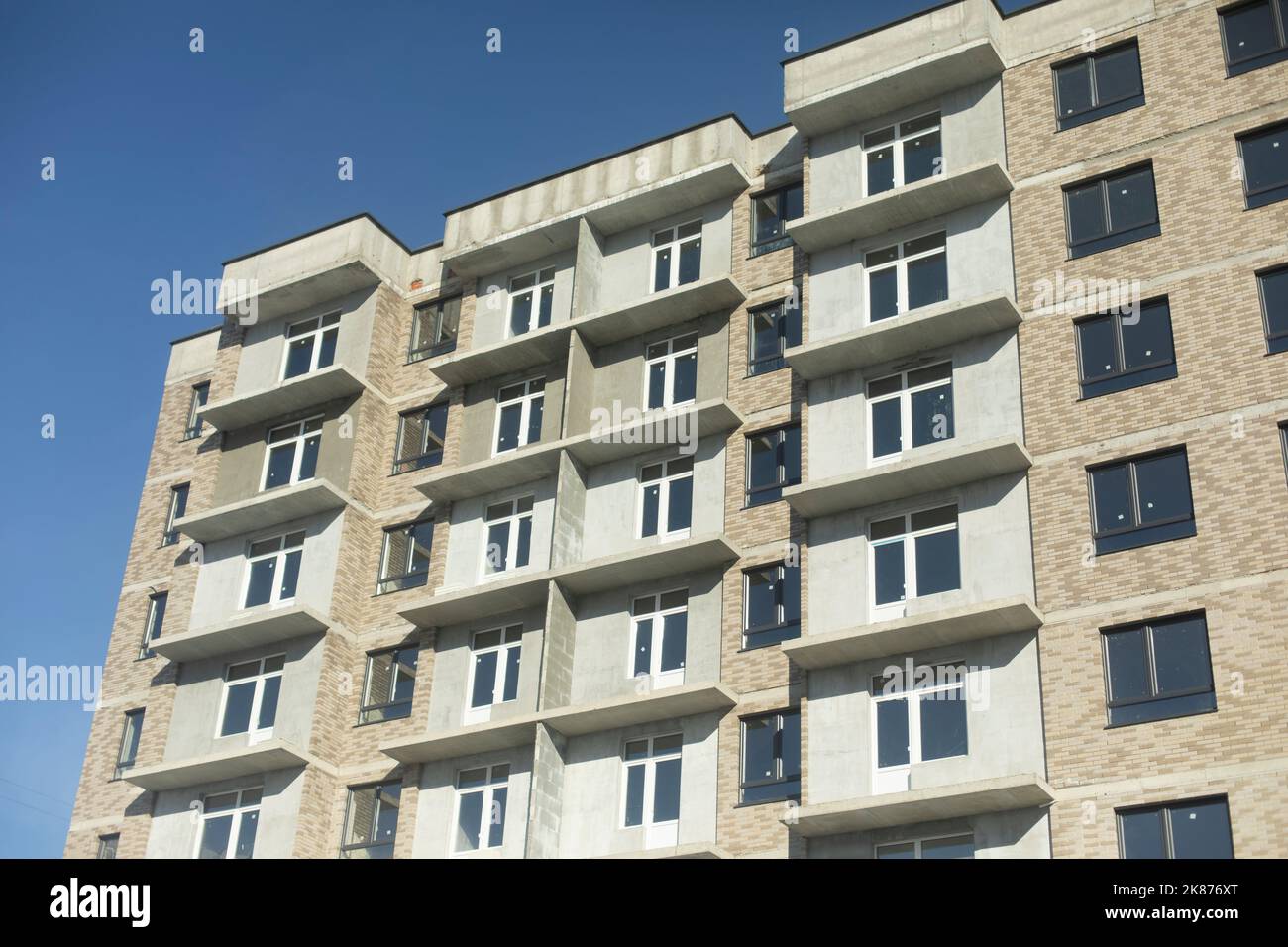 Construction of building. House with windows. New building. Balconies ...