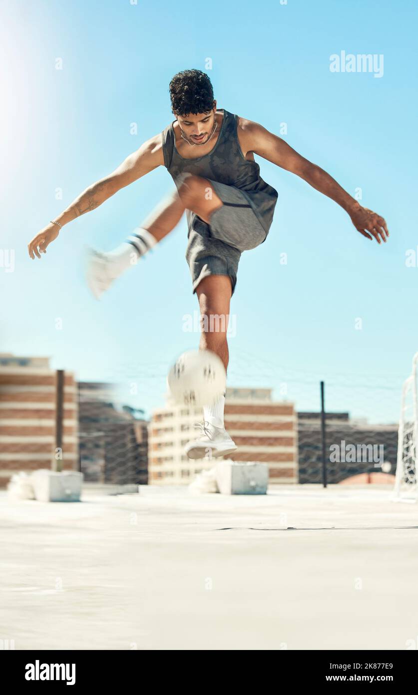 Soccer, jump and man in the air in the city of Brazil for training ...