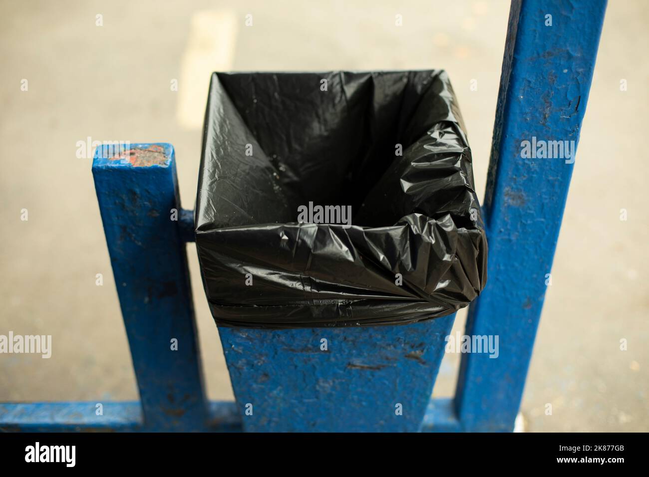 Urn with bag. Place for garbage. Trash can with black bag. Public ...
