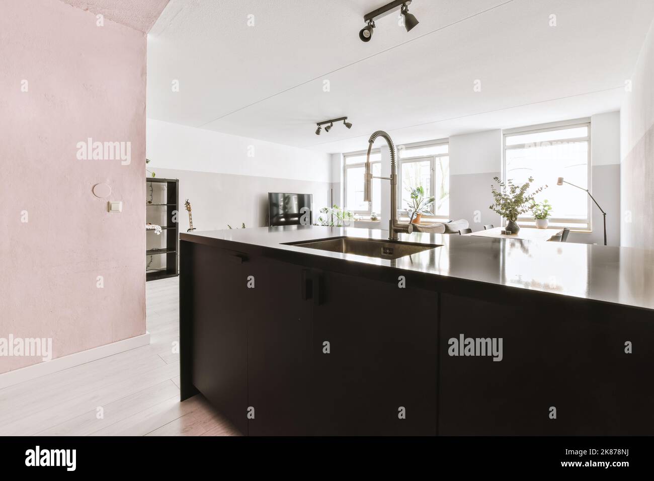 Simple interior of light living room with gray sofa in front of TV and ...