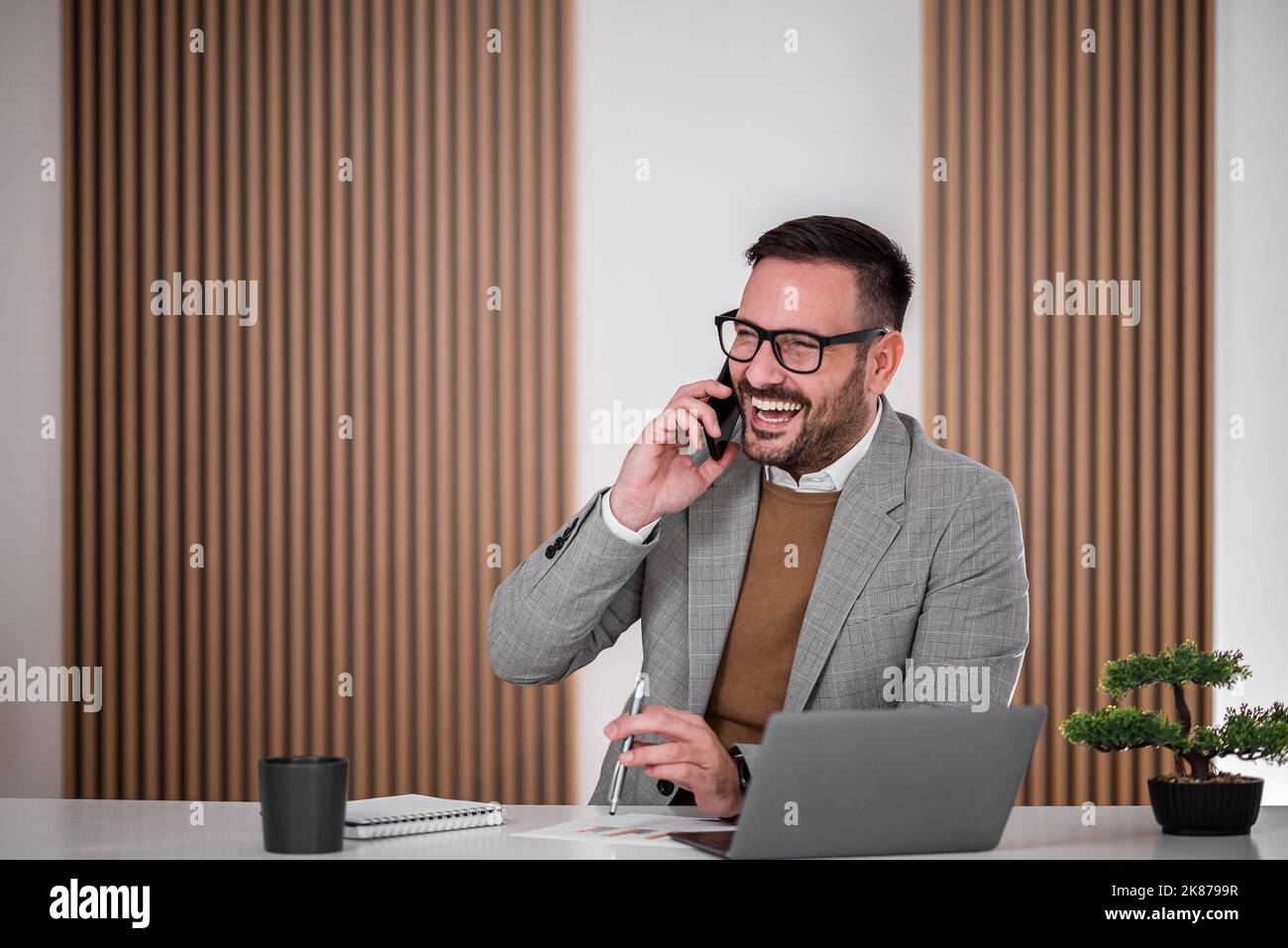 Cheerful entrepreneur or businessman, having a conversation on his ...