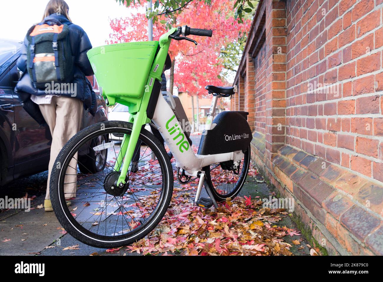 Lime Micromobility bike with green basket in front of bike, parks in ...