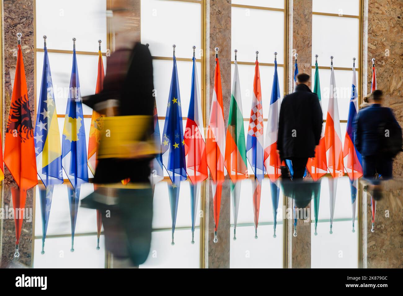 Berlin, Germany. 21st Oct, 2022. People walk in front of flags at the ...