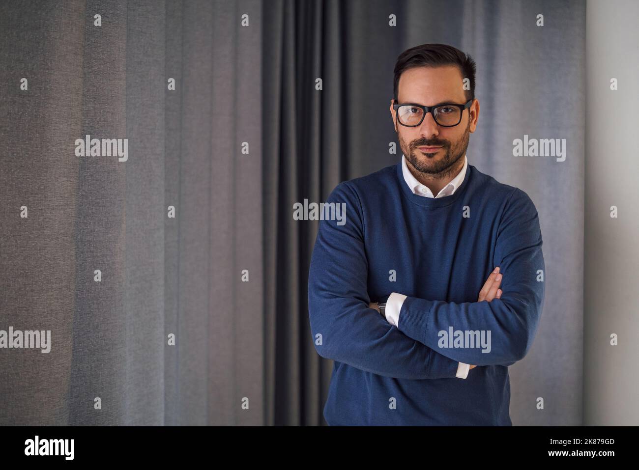 Picture of ambitious handsome young adult man, standing cross-armed ...