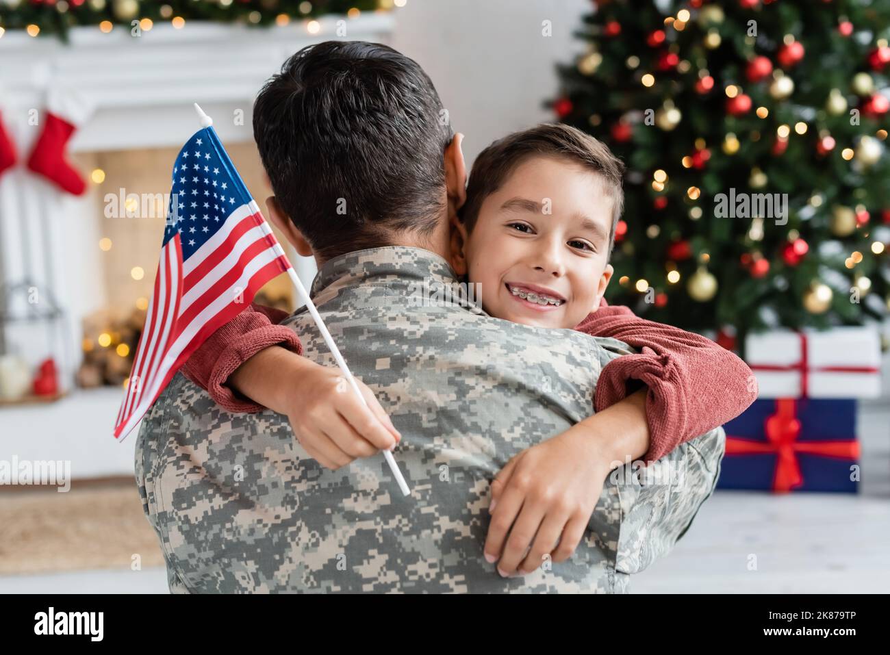 happy boy in dental braces holding usa flag and embracing father in ...