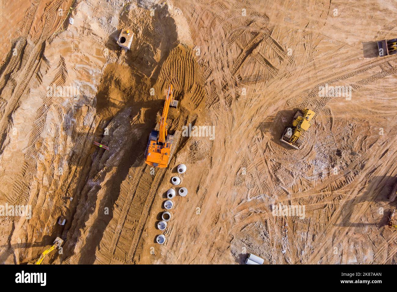 Construction site an excavator digging trench for laying sewer lines ...