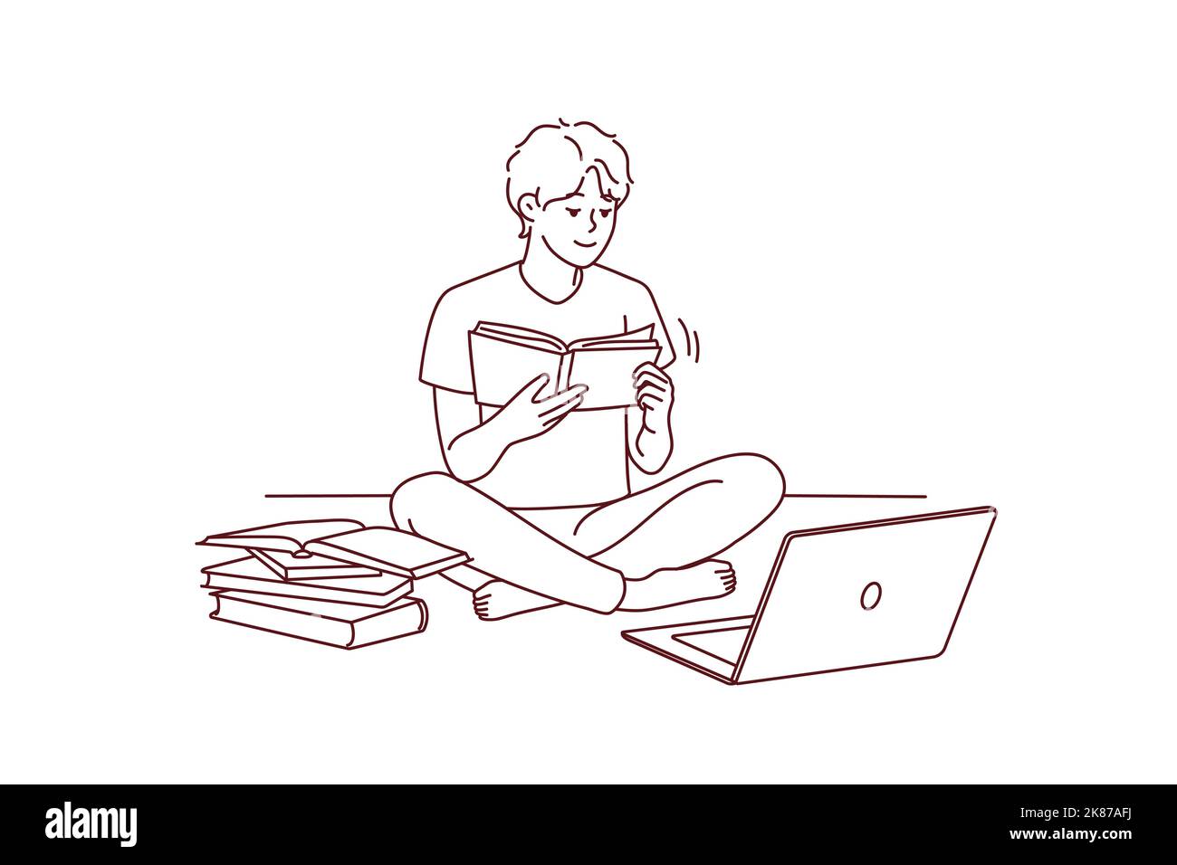 Guy sit on floor study on compute read textbooks prepare for exam ...