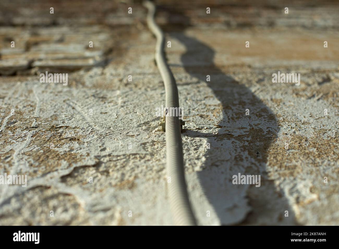 Wire on wall. Electrical wiring in building. Current insulation ...