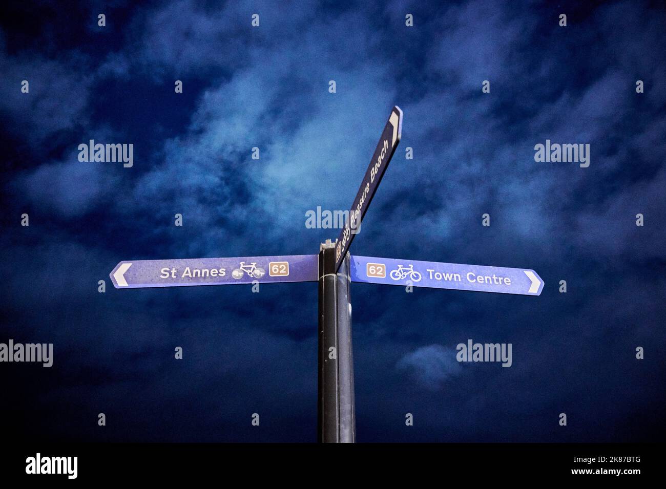 Cycle route sign by moonlight Stock Photo - Alamy