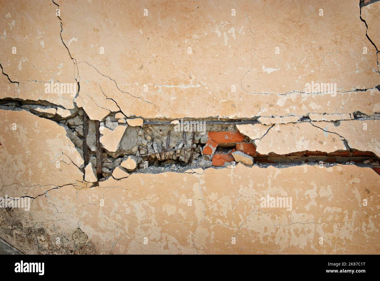 Cracked wall with metal inserts Stock Photo - Alamy
