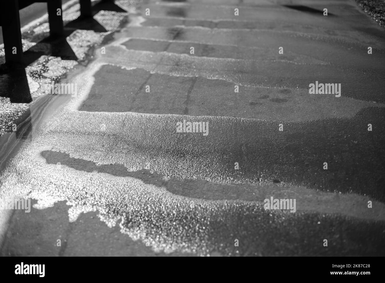 Puddle in road. Water on asphalt. Wet surface Stock Photo - Alamy