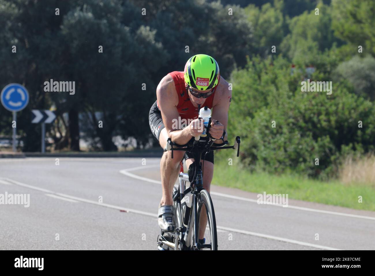 triathlete cycling on a bike drinking from a water bottle Stock Photo ...