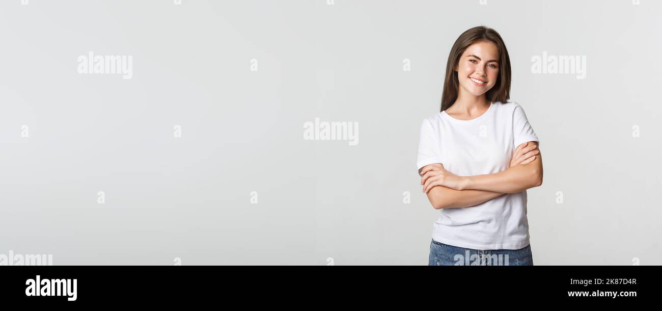 Portrait of confident attractive woman, cross arms chest and smiling ...