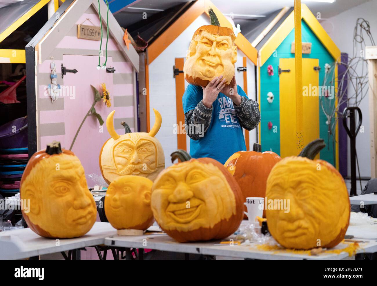 Sculptor Dunc Foster moves a pumpkin in a workshop, ahead of the ...