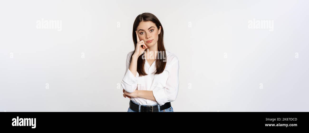 Unamused, bored brunette woman looking gloomy and sad, sighing ...