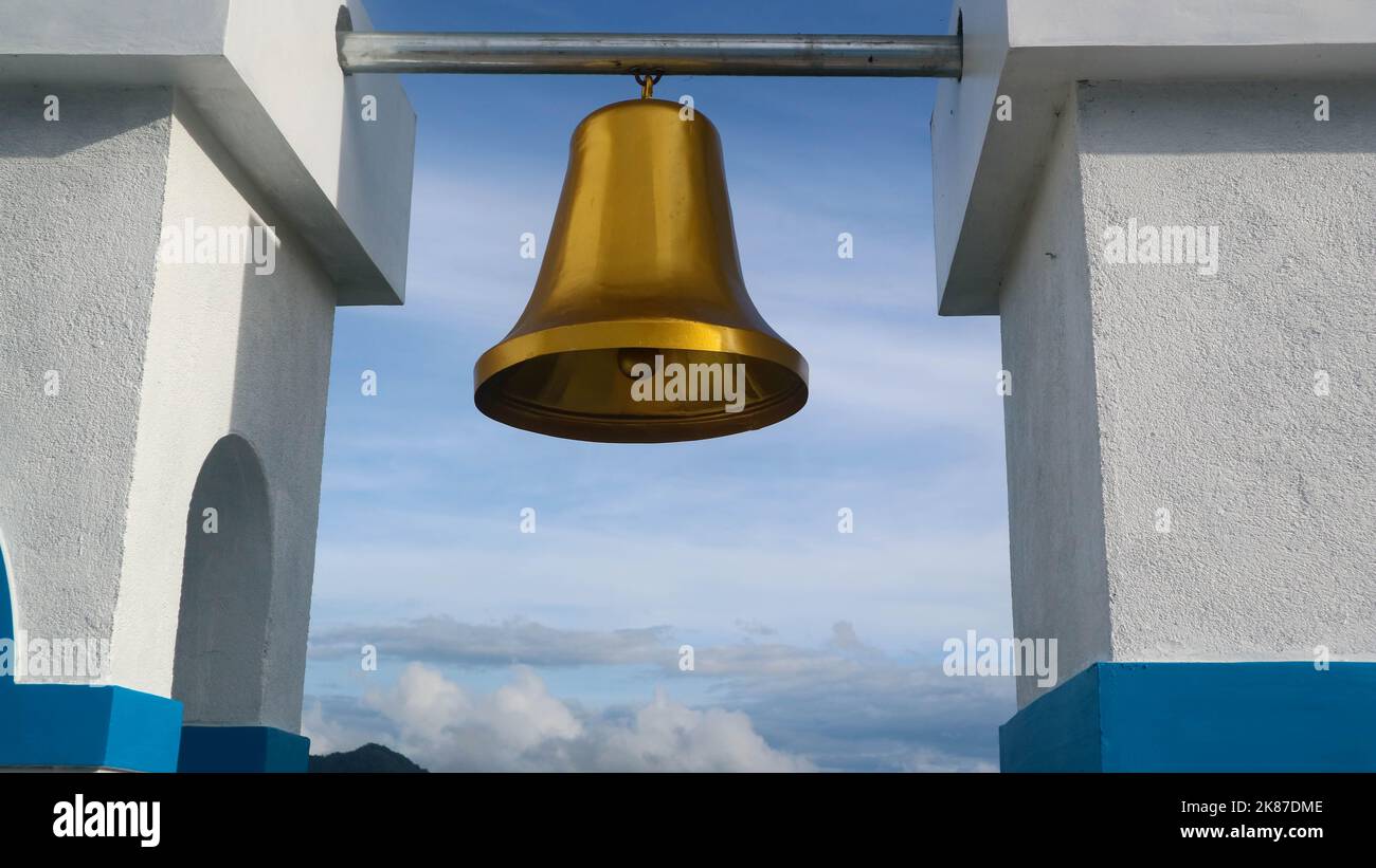a golden bell and a blue sky Stock Photo - Alamy