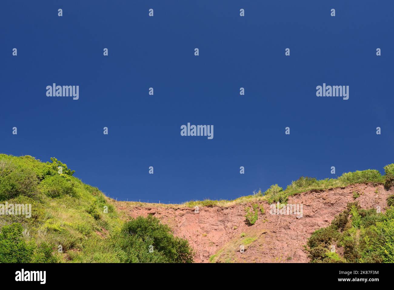 A deep blue sky above a red sandstone clifftop, photographed with a ...